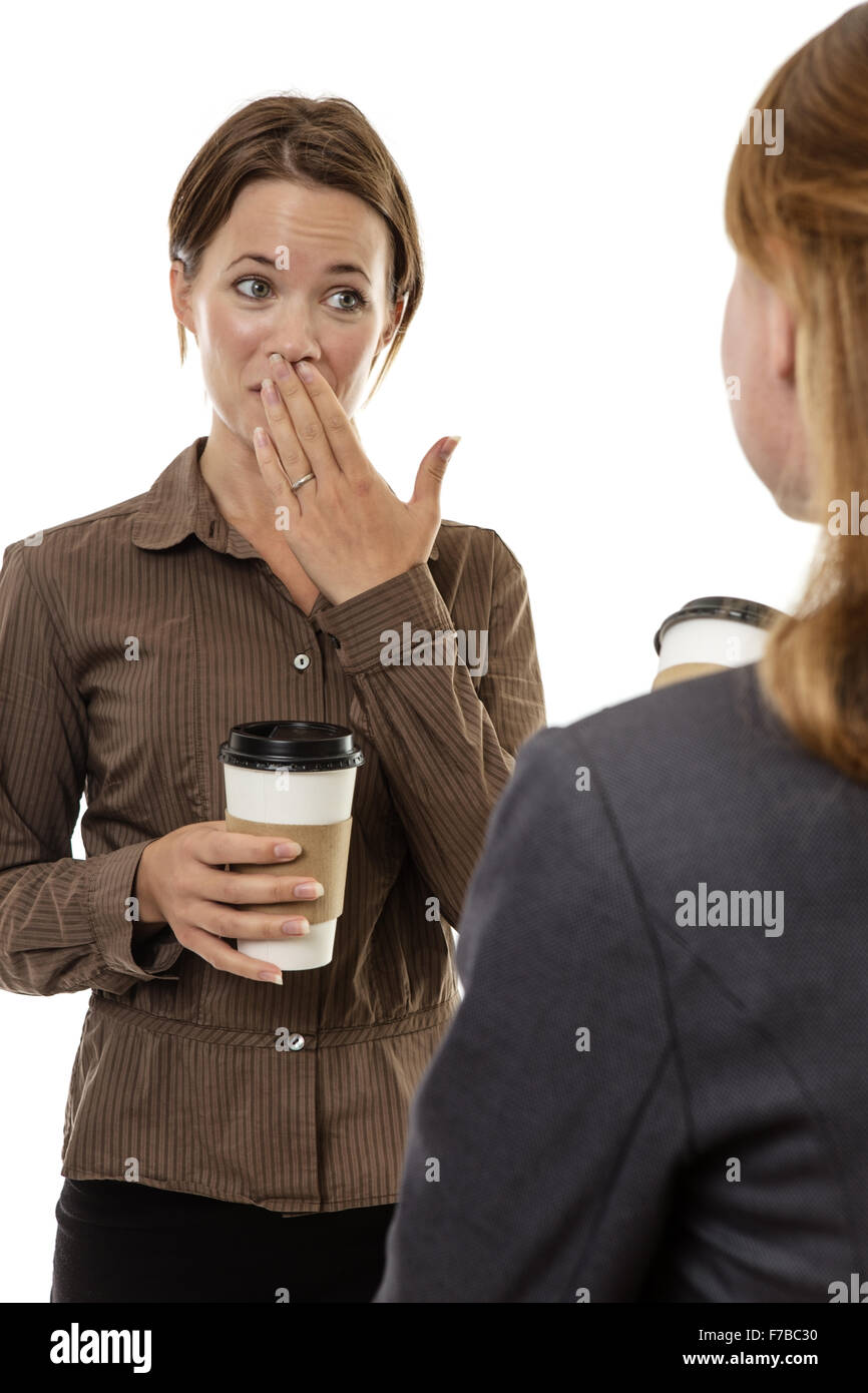 Two business woman chatting and enjoying a gossip over a coffee ...