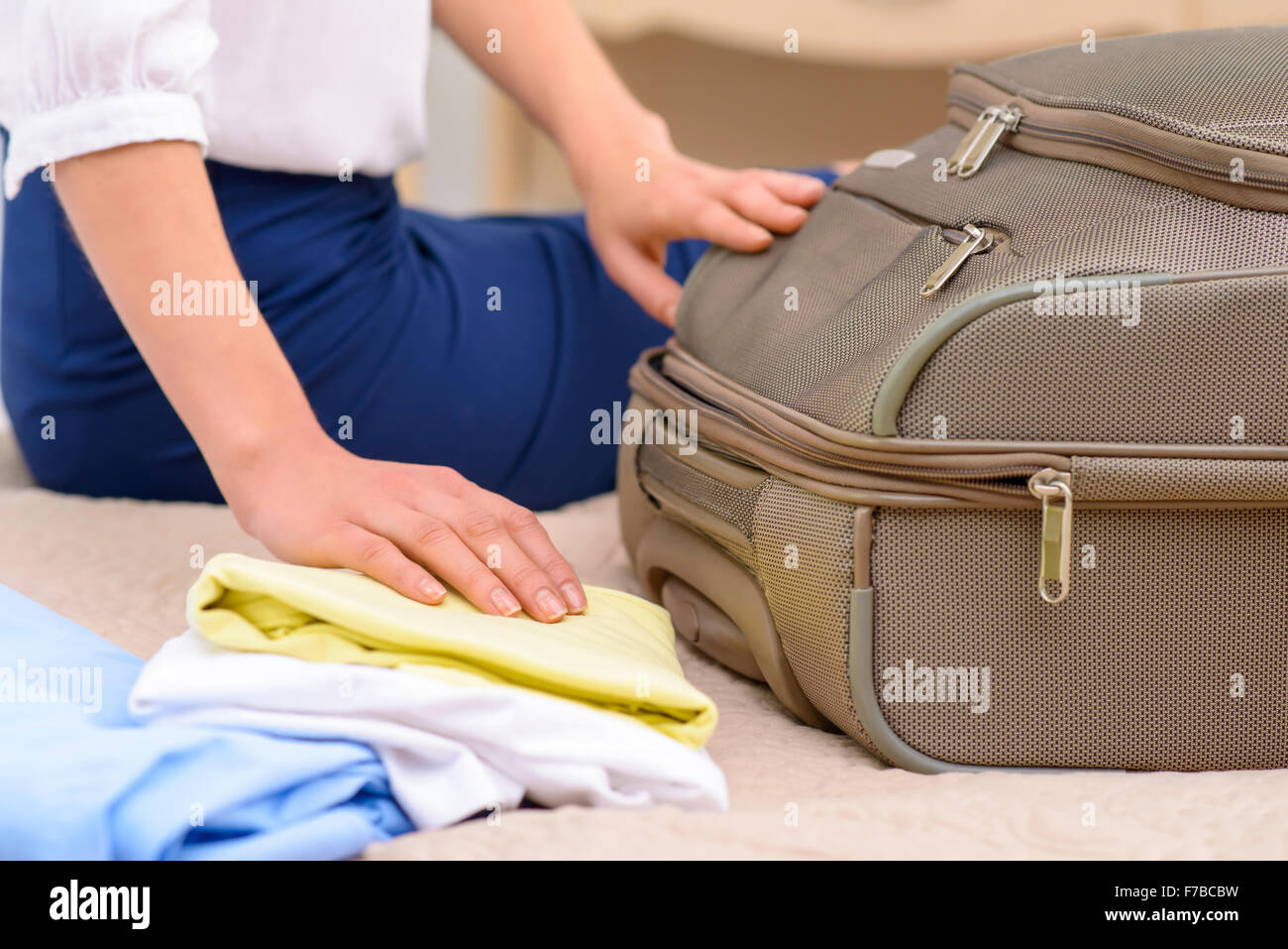 Female tourist unpacking her baggage Stock Photo - Alamy