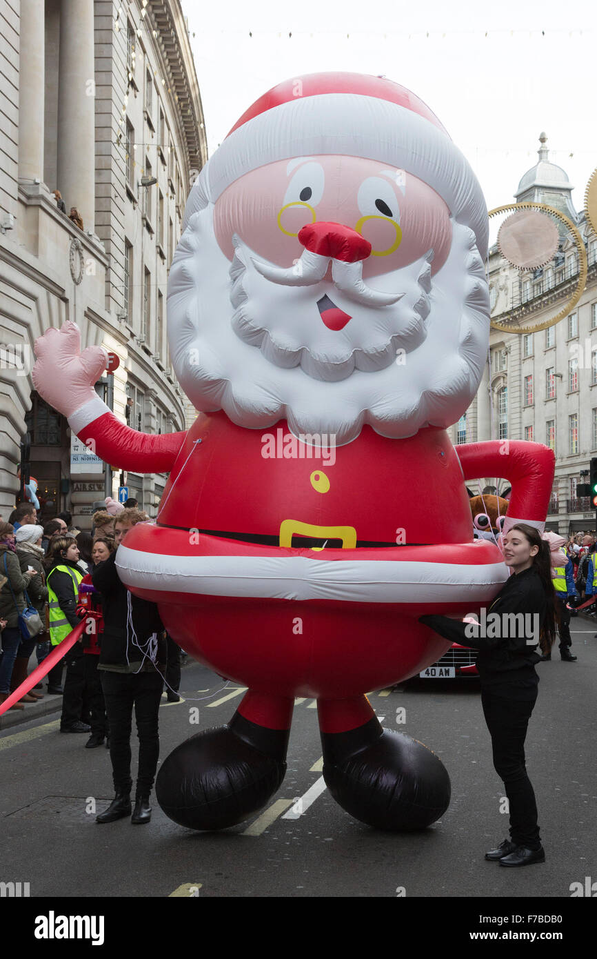 London, UK. 28 November 2015. An inflatable Santa Claus on parade. The ...