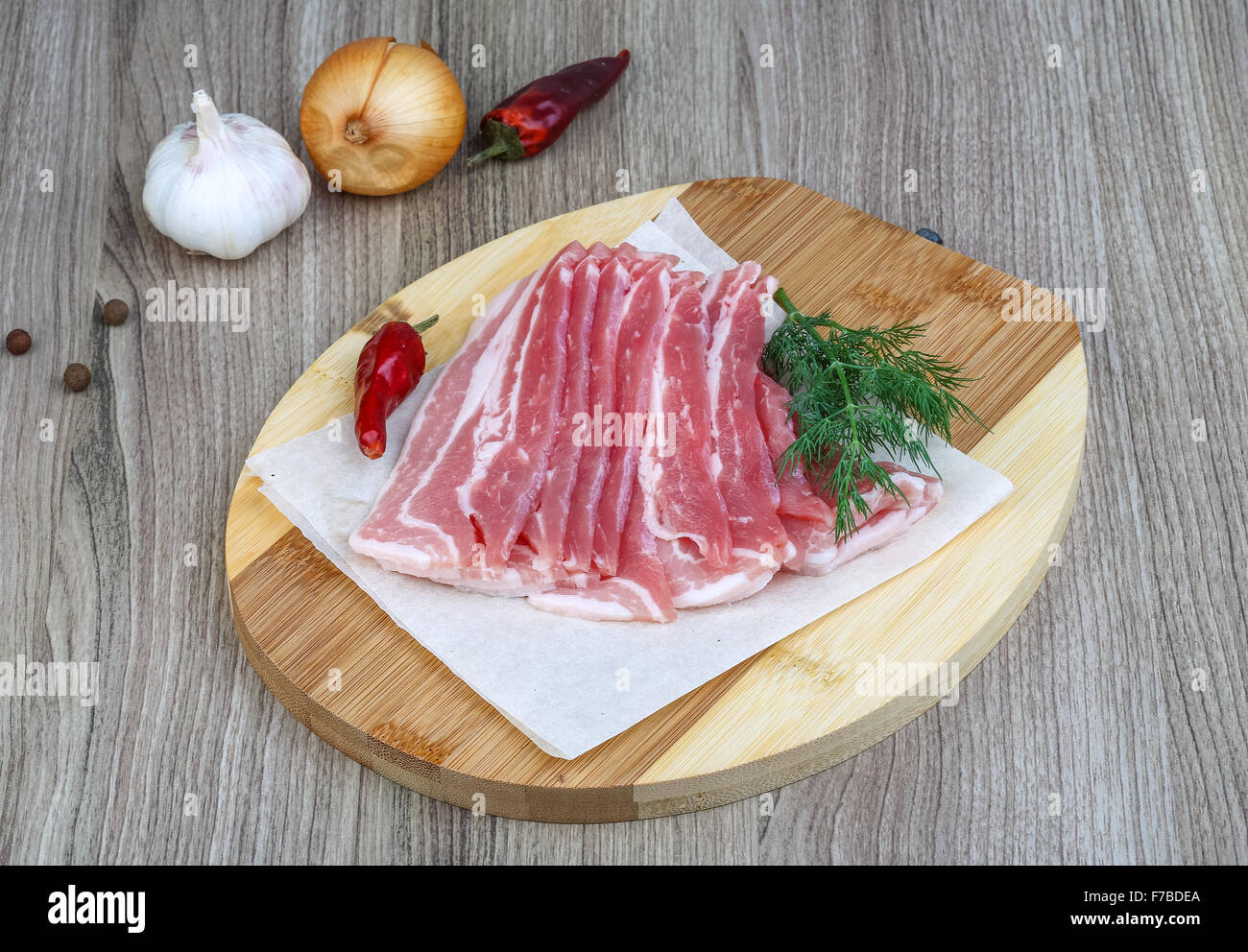 Raw bacon on the wood board with dill leaves Stock Photo - Alamy