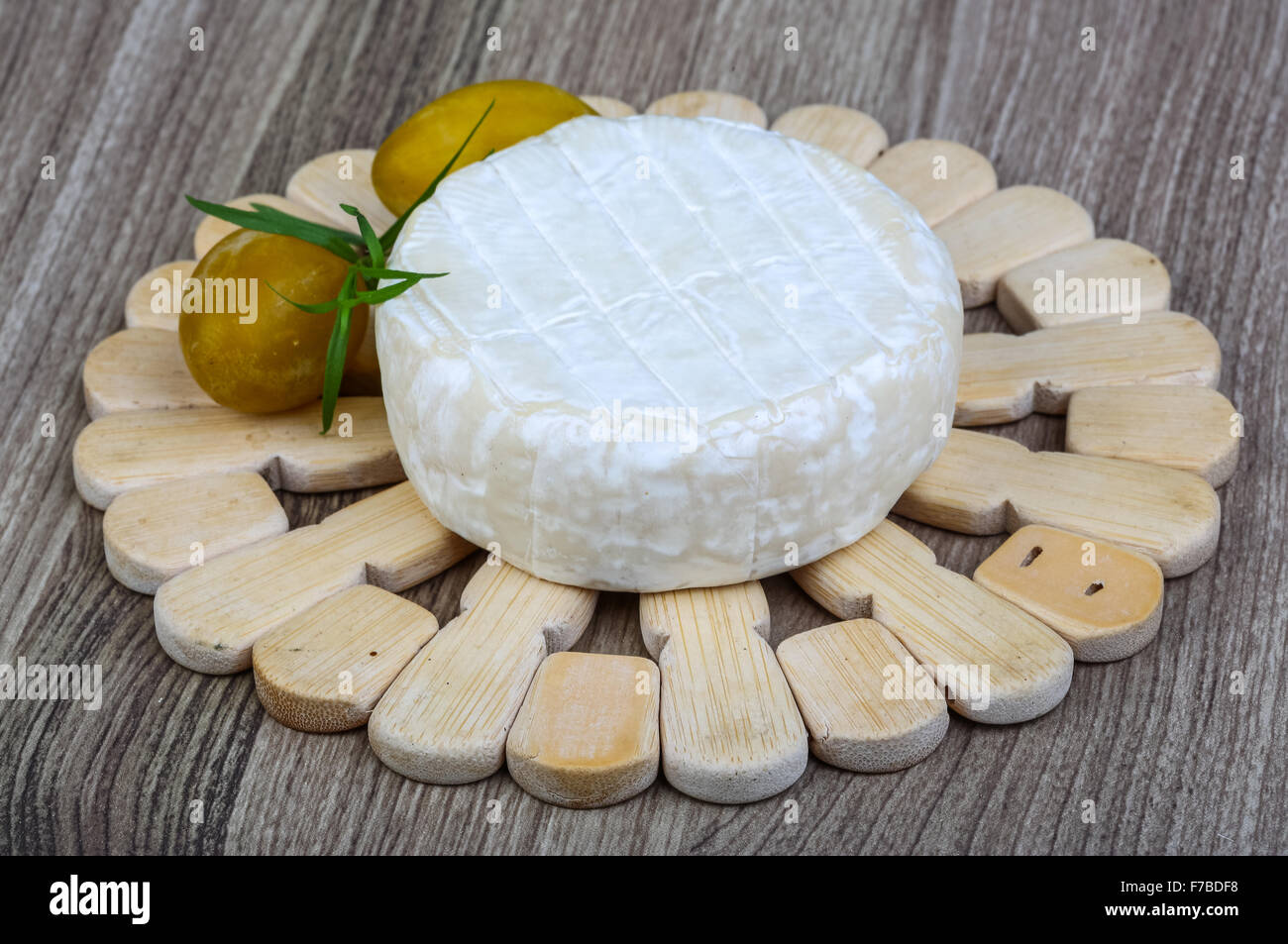 Round Brie cheese with yellow plums and estragon Stock Photo - Alamy