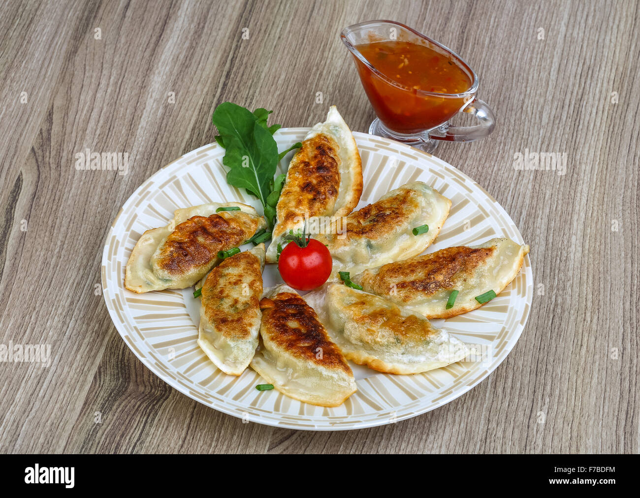 Japanese cousine - Gyoza served green onion and cherry tomato Stock ...