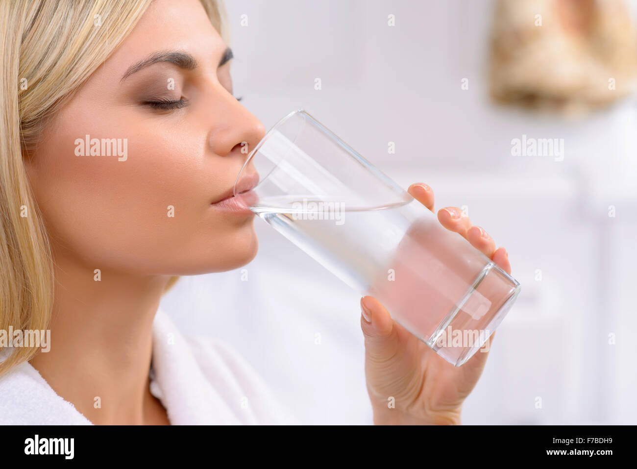 Young lady drinking water Stock Photo - Alamy