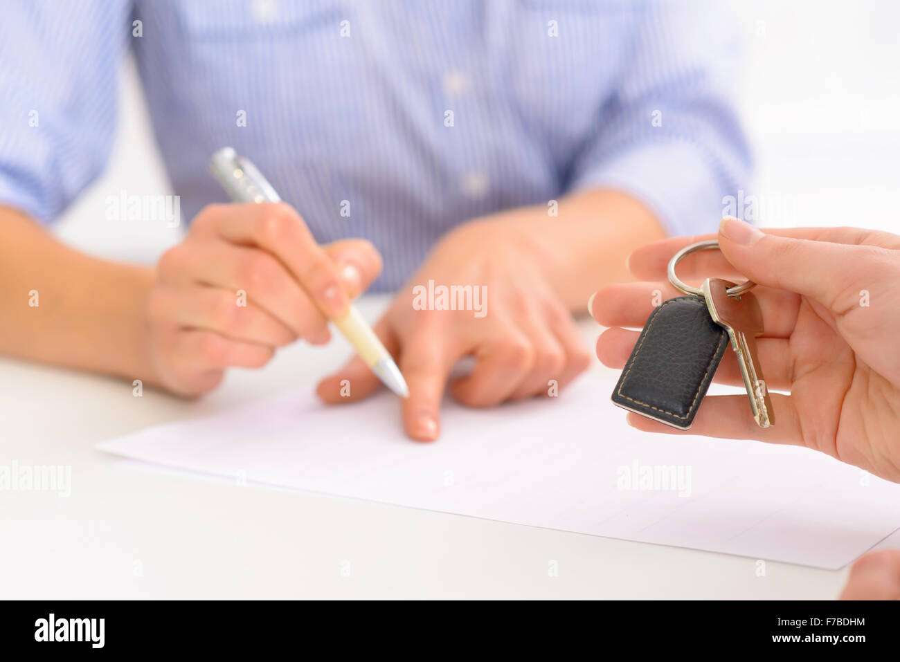Receptionist helping to fill out the forms Stock Photo - Alamy
