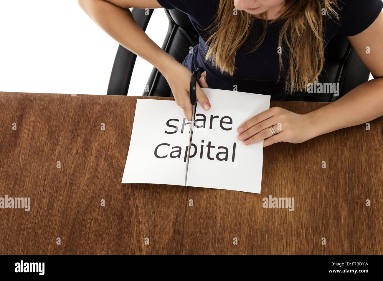 woman shot from above cutting paper in half with the words share ...