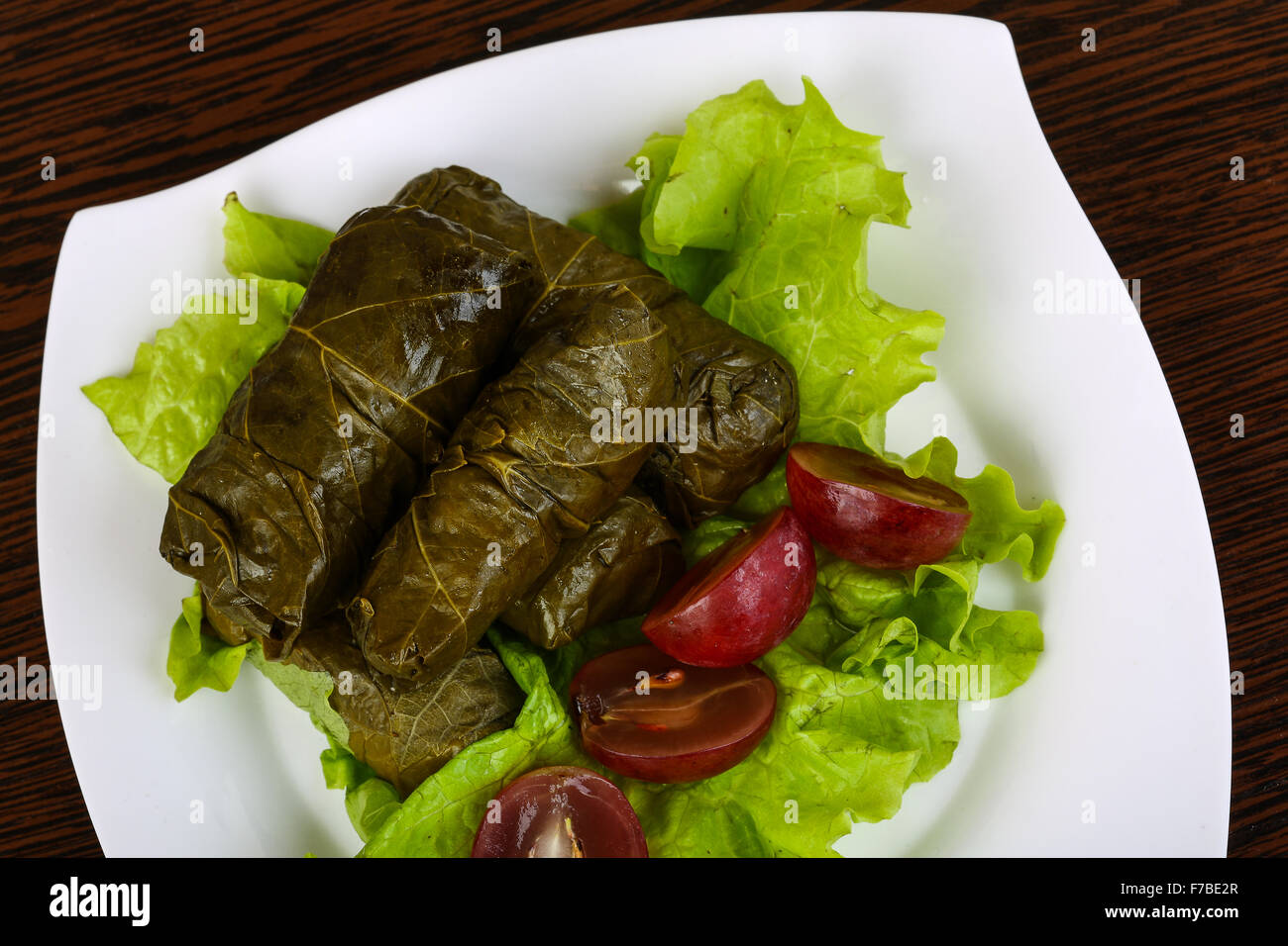 Dolma - minced meat in grape leaves with salad Stock Photo - Alamy