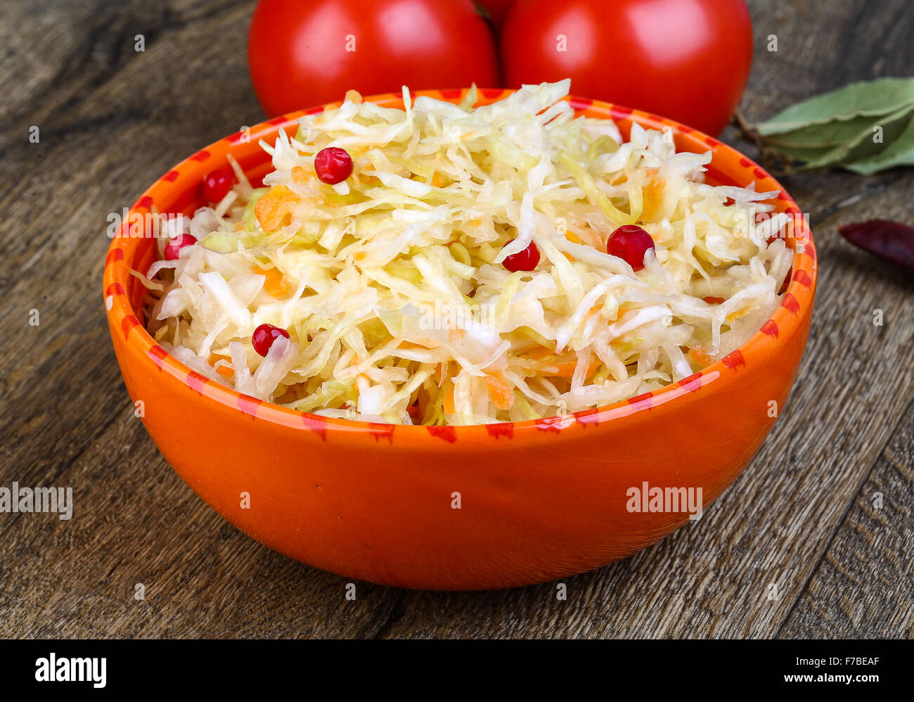 Fermented cabbage - Sauerkraut with herbs and spices on the wood ...