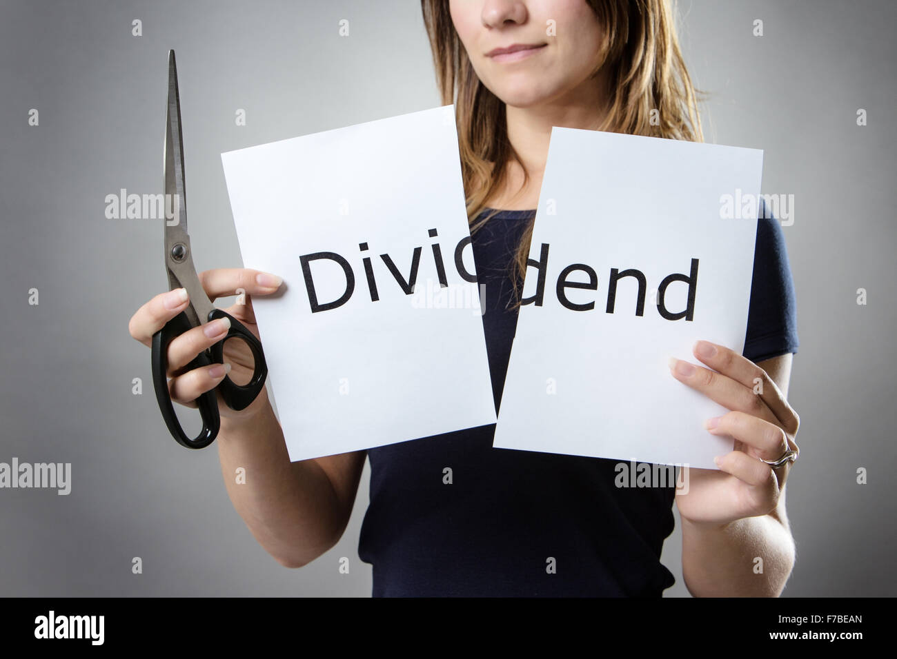 stand woman cutting paper in half with the word share capital written ...