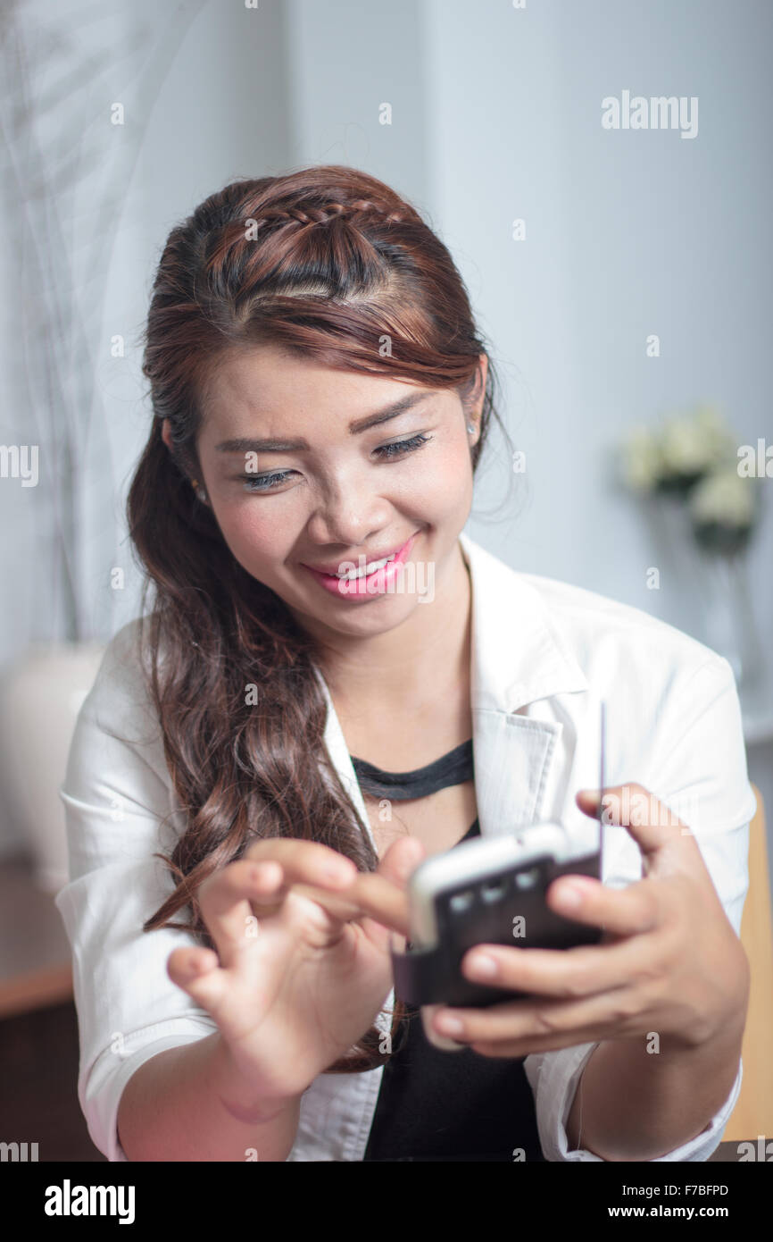 Asian worker using smartphone Stock Photo - Alamy