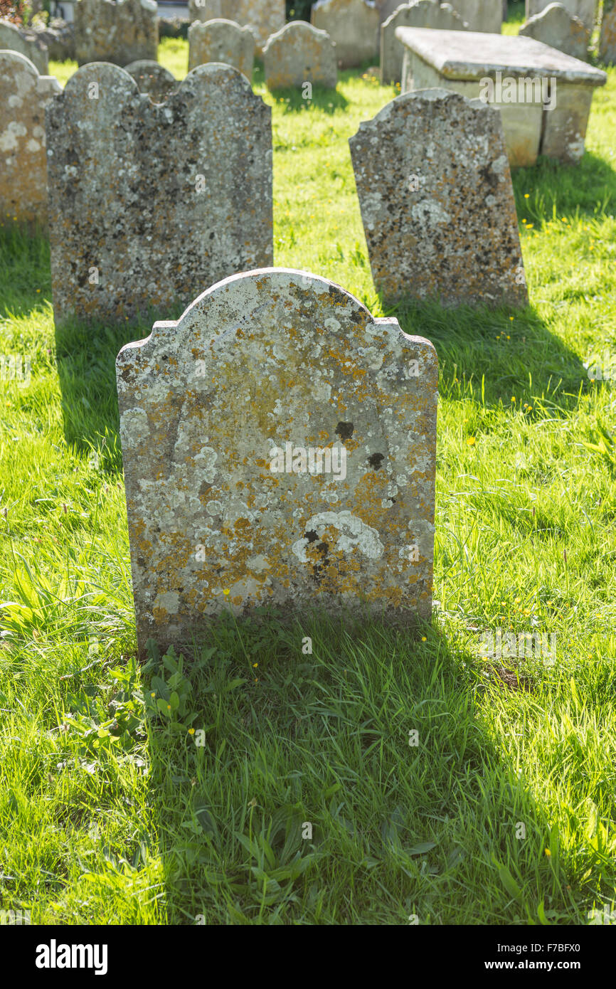 Old Gravestones in a Graveyard being backlit by the sun Stock Photo - Alamy
