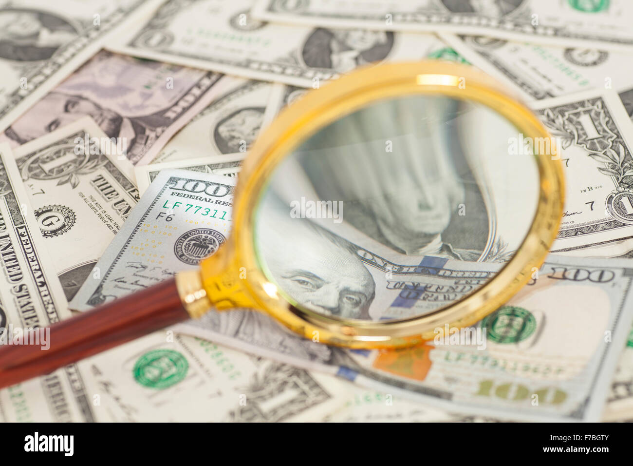 dollar banknotes under magnifying glass Stock Photo - Alamy