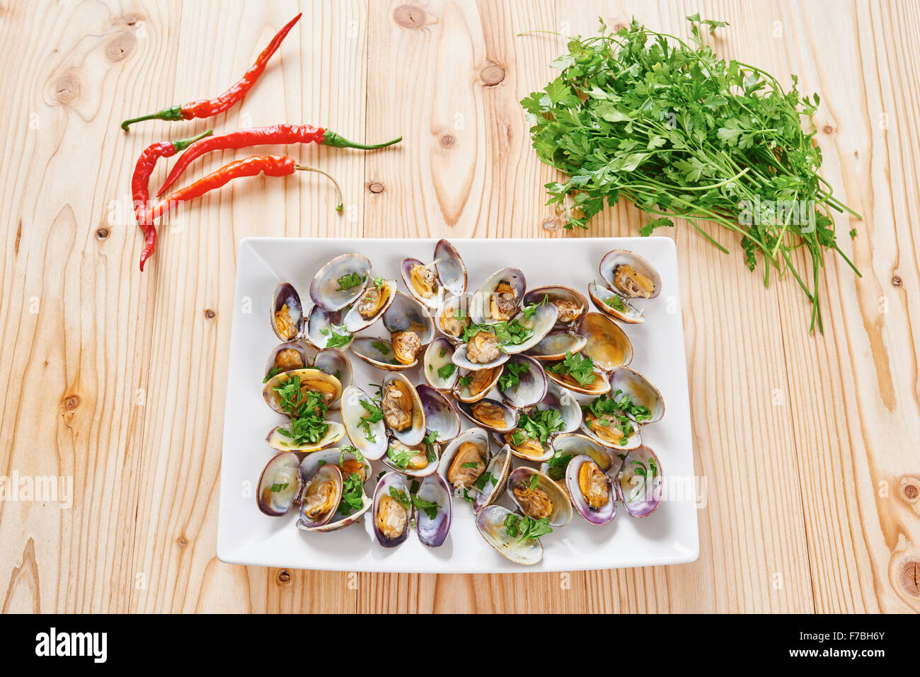 Steamed clams on white square plate Stock Photo - Alamy