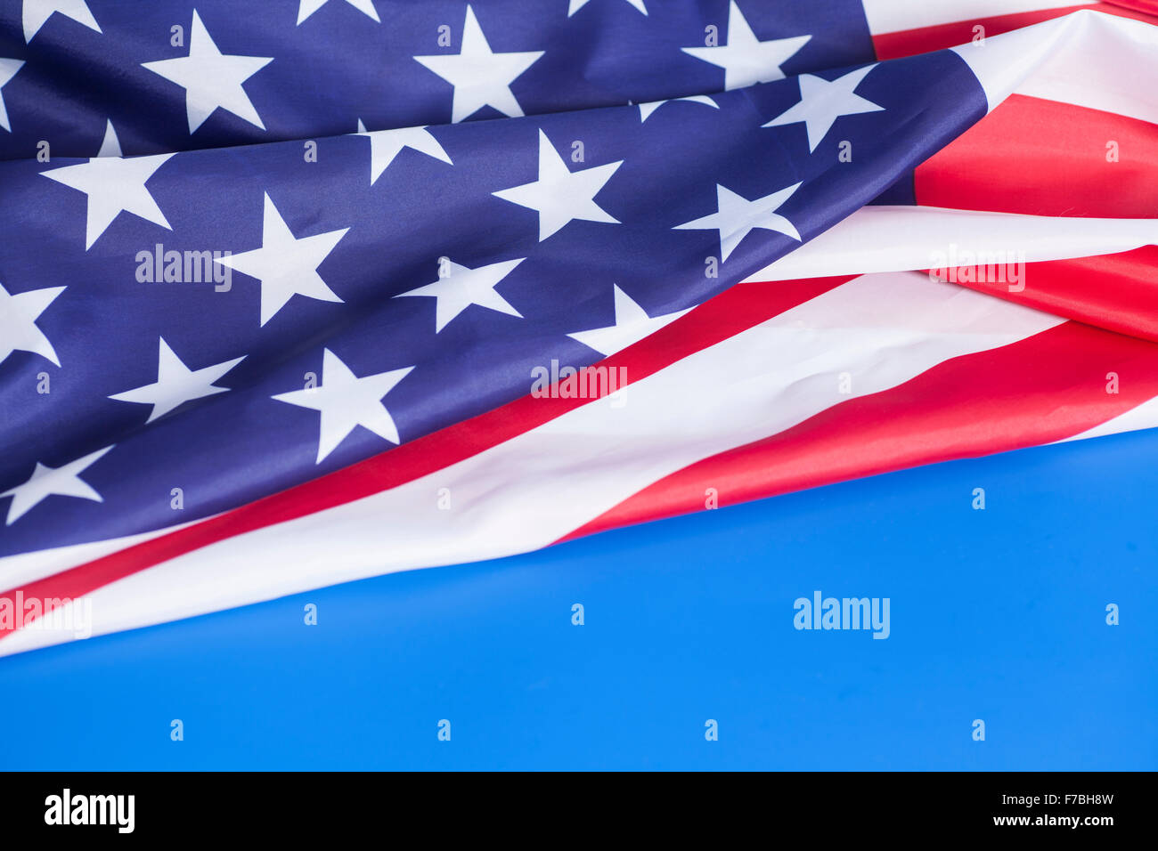 Closeup of American flag on blue background Stock Photo - Alamy