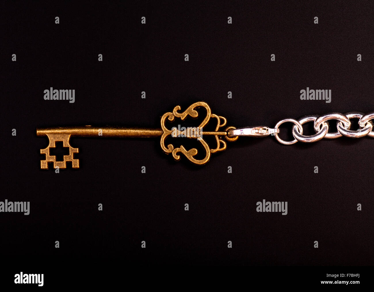Vintage Key with chain on black background Stock Photo - Alamy