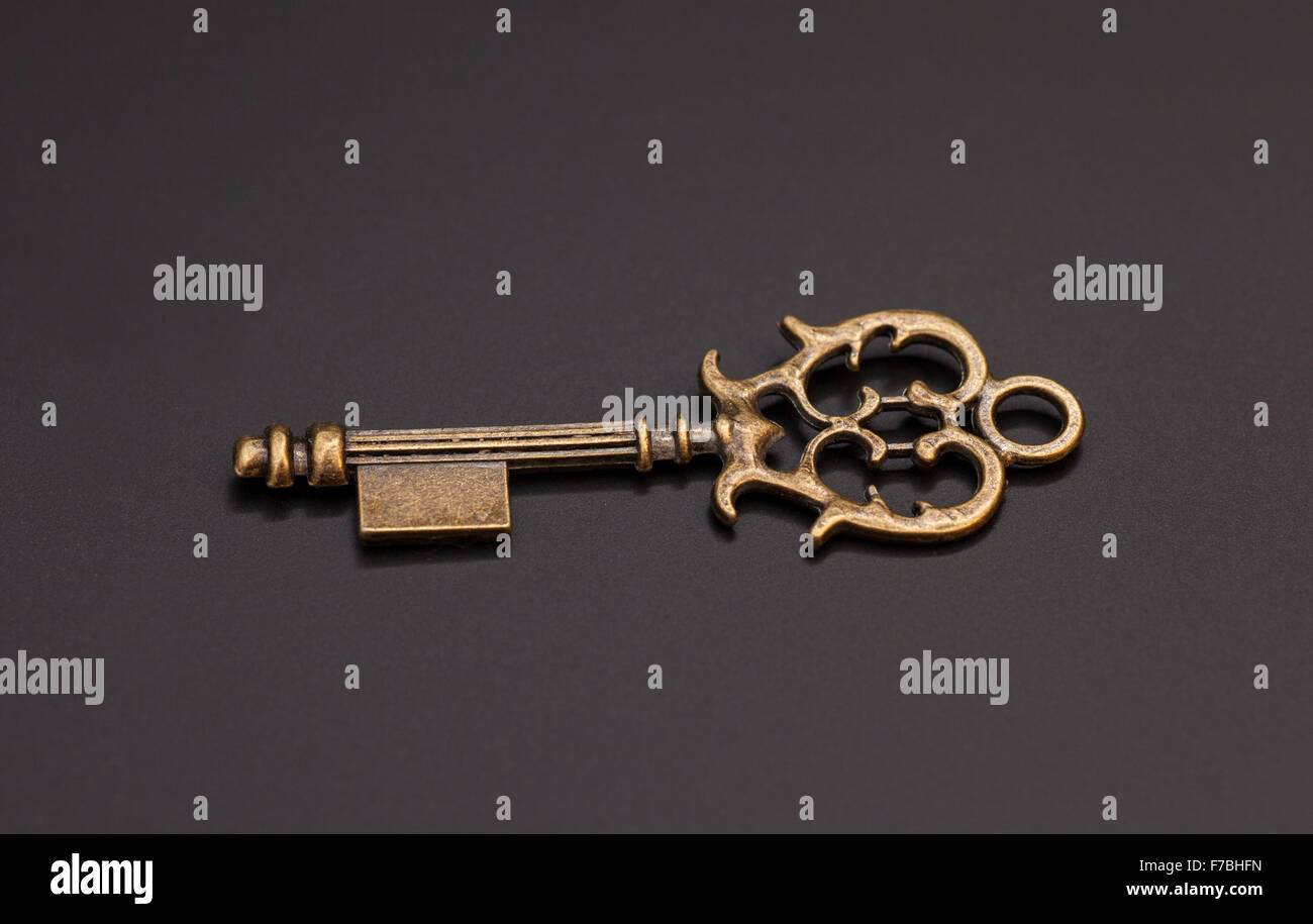 Vintage Key with chain on black background Stock Photo - Alamy