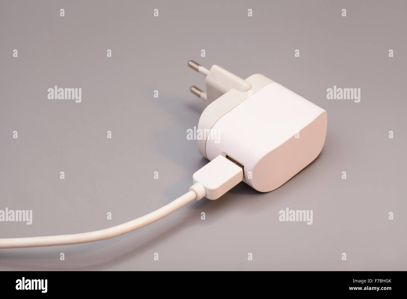 Electrical adapter to USB port on a gray background Stock Photo - Alamy