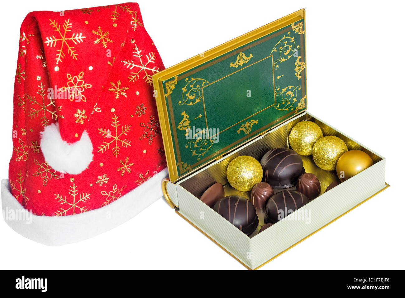 A box of chocolates for Christmas and a Santa Claus hat. Presented on a ...