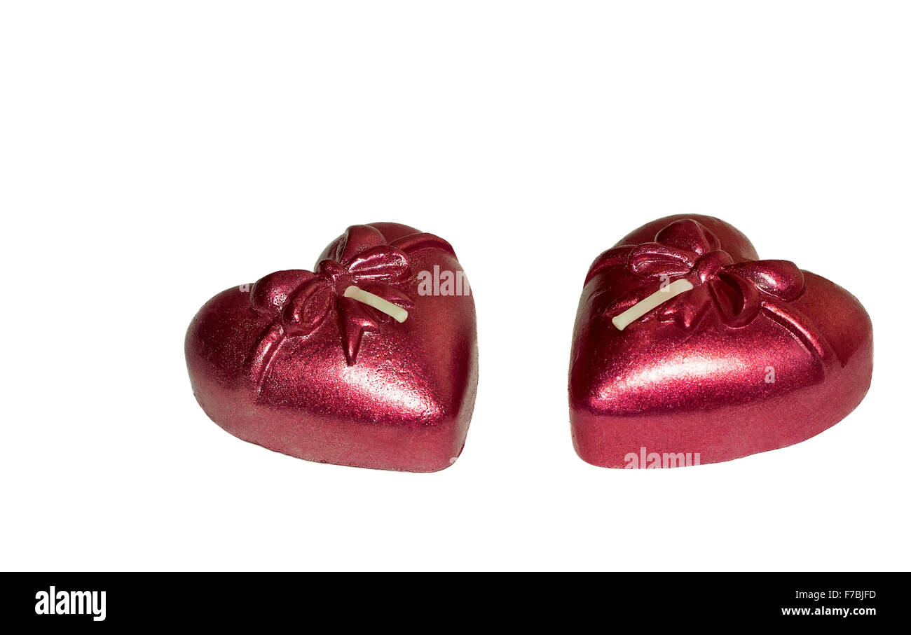 Two small candles dark cherry color in the shape of a heart. Presented ...