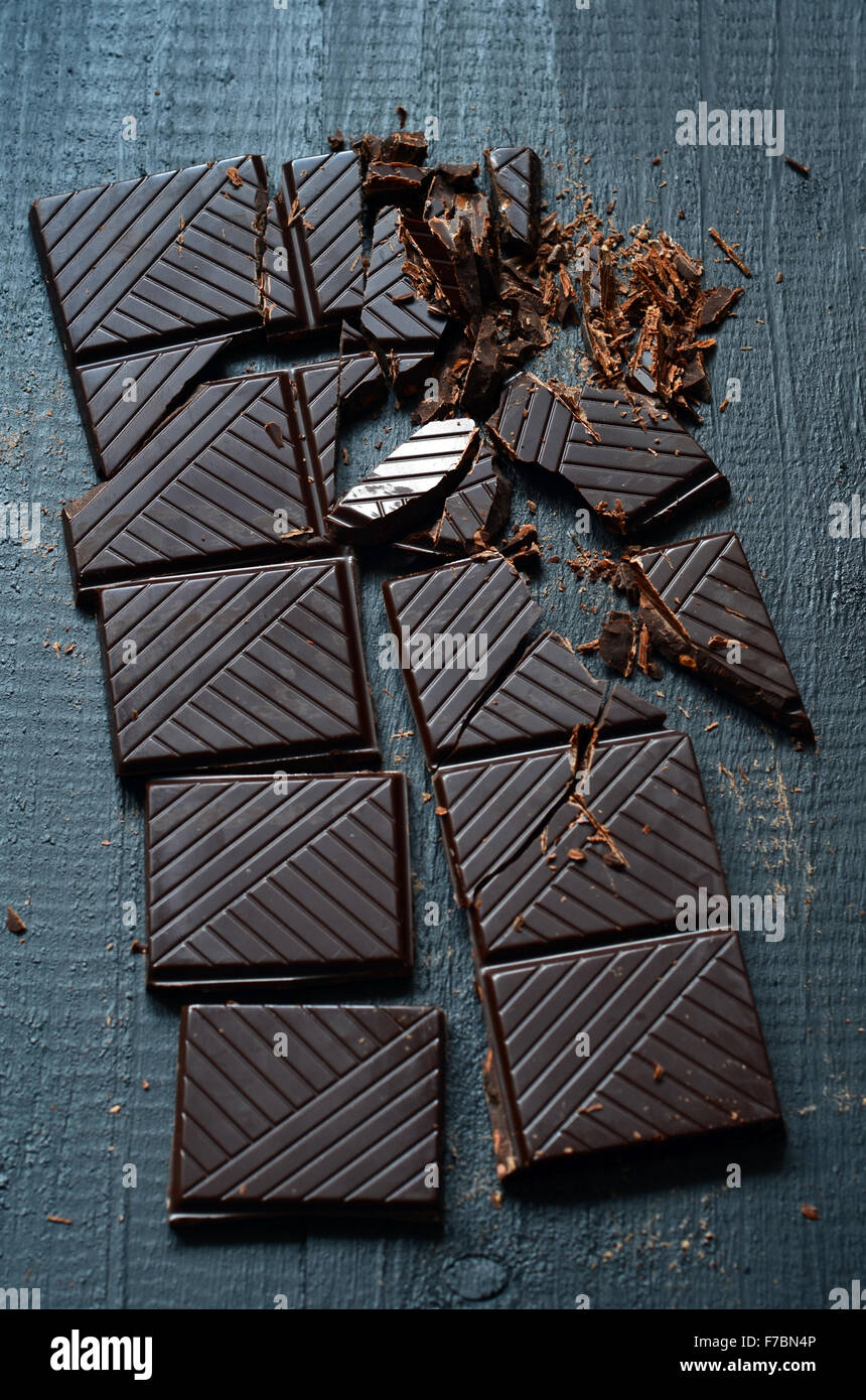 Shredded Dark Chocolate for Cooking on dark wooden background Stock ...