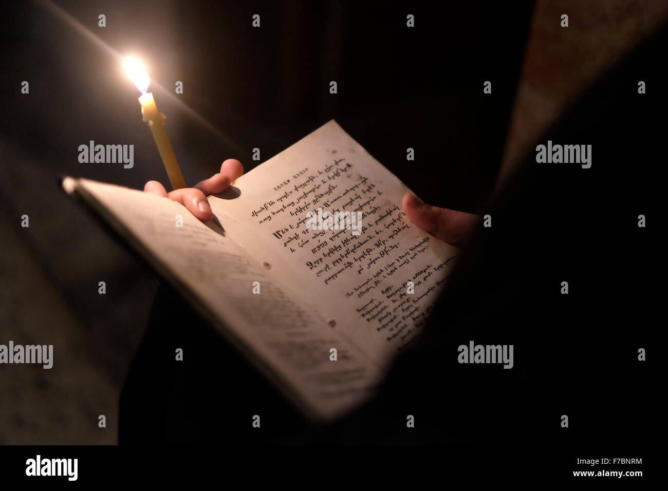 An Armenian Apostolic cleric reading a sacred script in Armenian ...