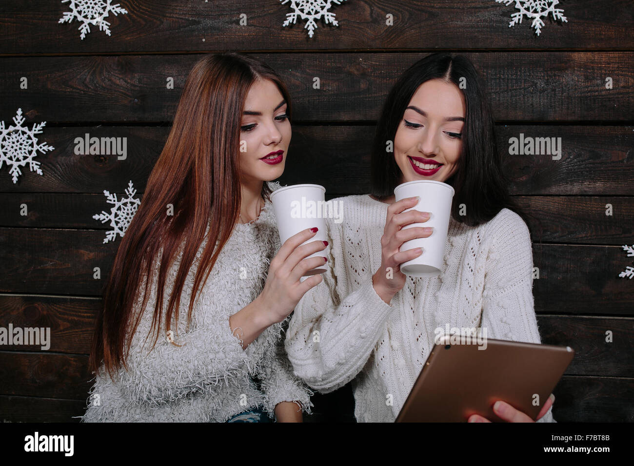 Two girls watching something on a tablet Stock Photo - Alamy