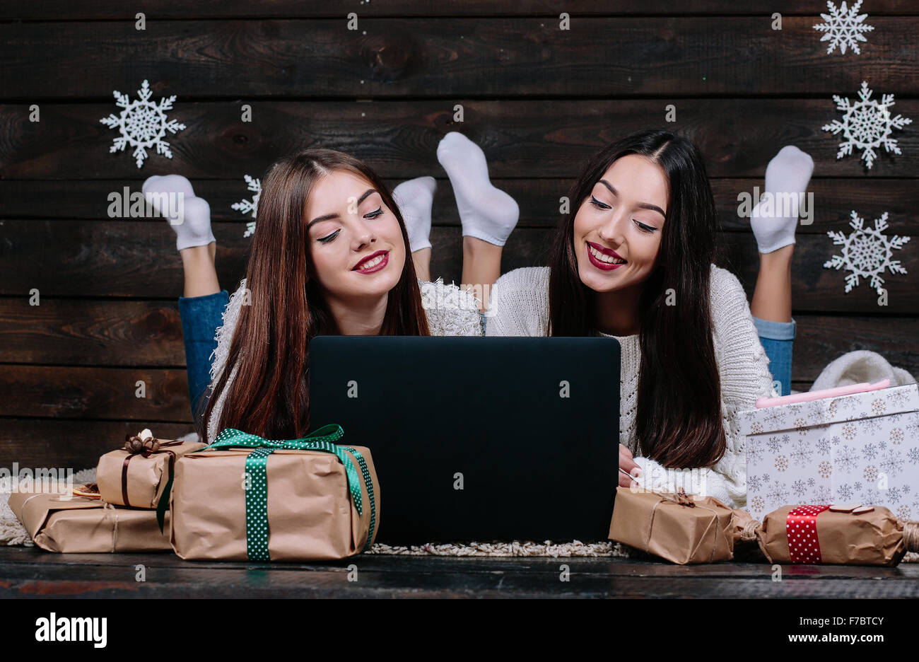 Two beautiful girls lie on the floor Stock Photo - Alamy