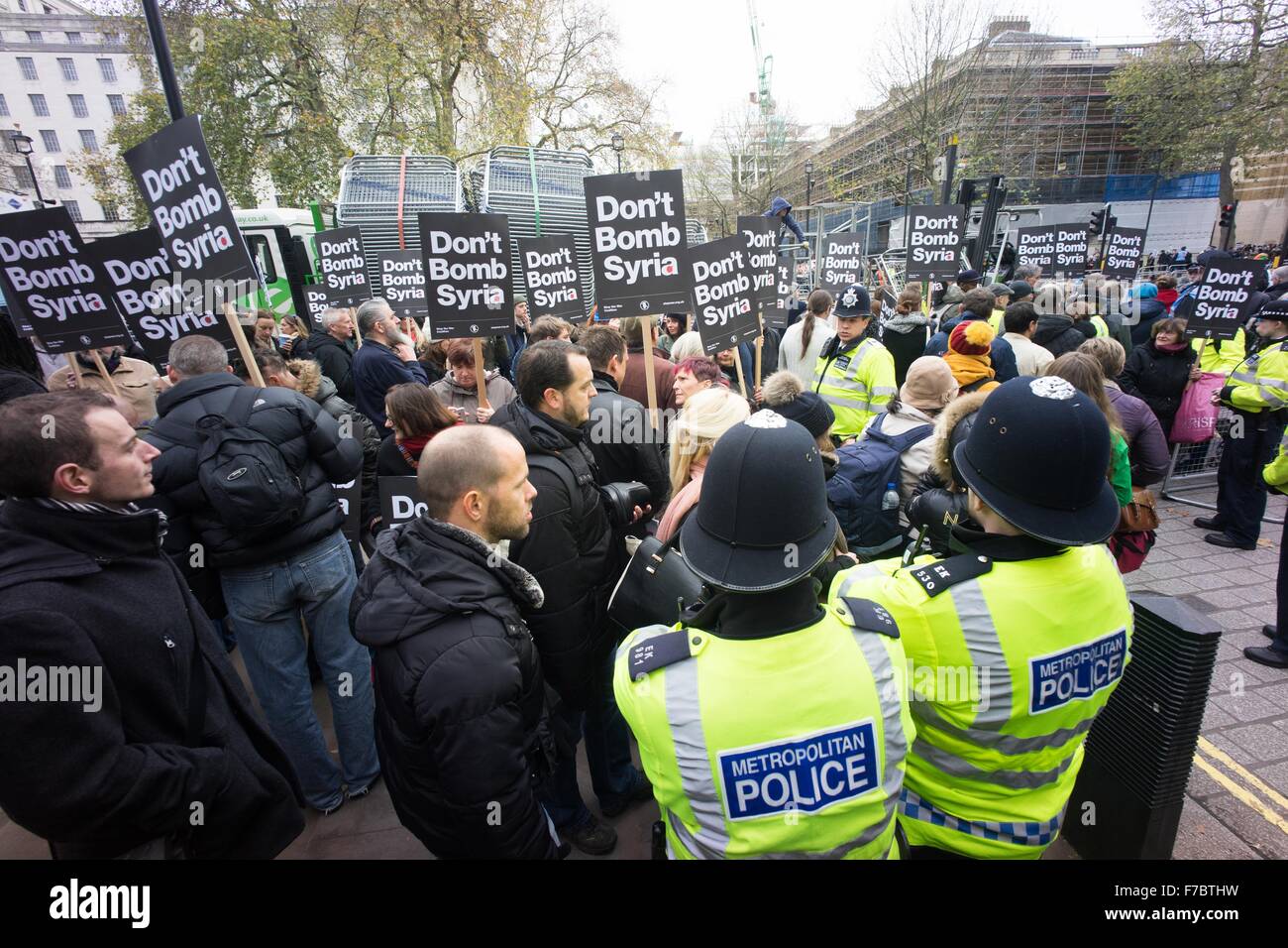 Police officer guarding the front gate of Downing Street as protester ...