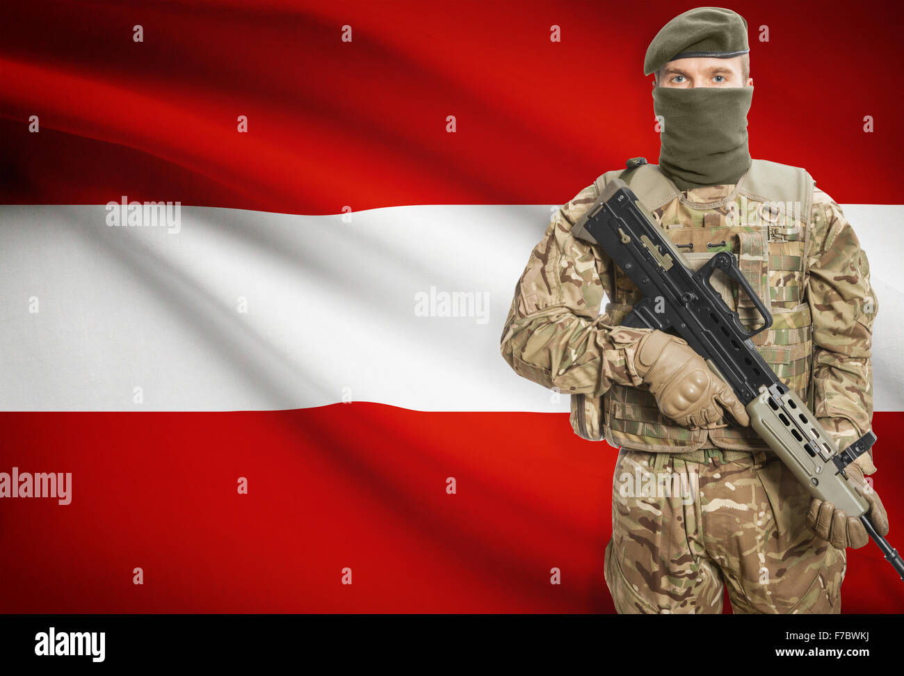 Soldier holding machine gun with national flag on background - Austria ...