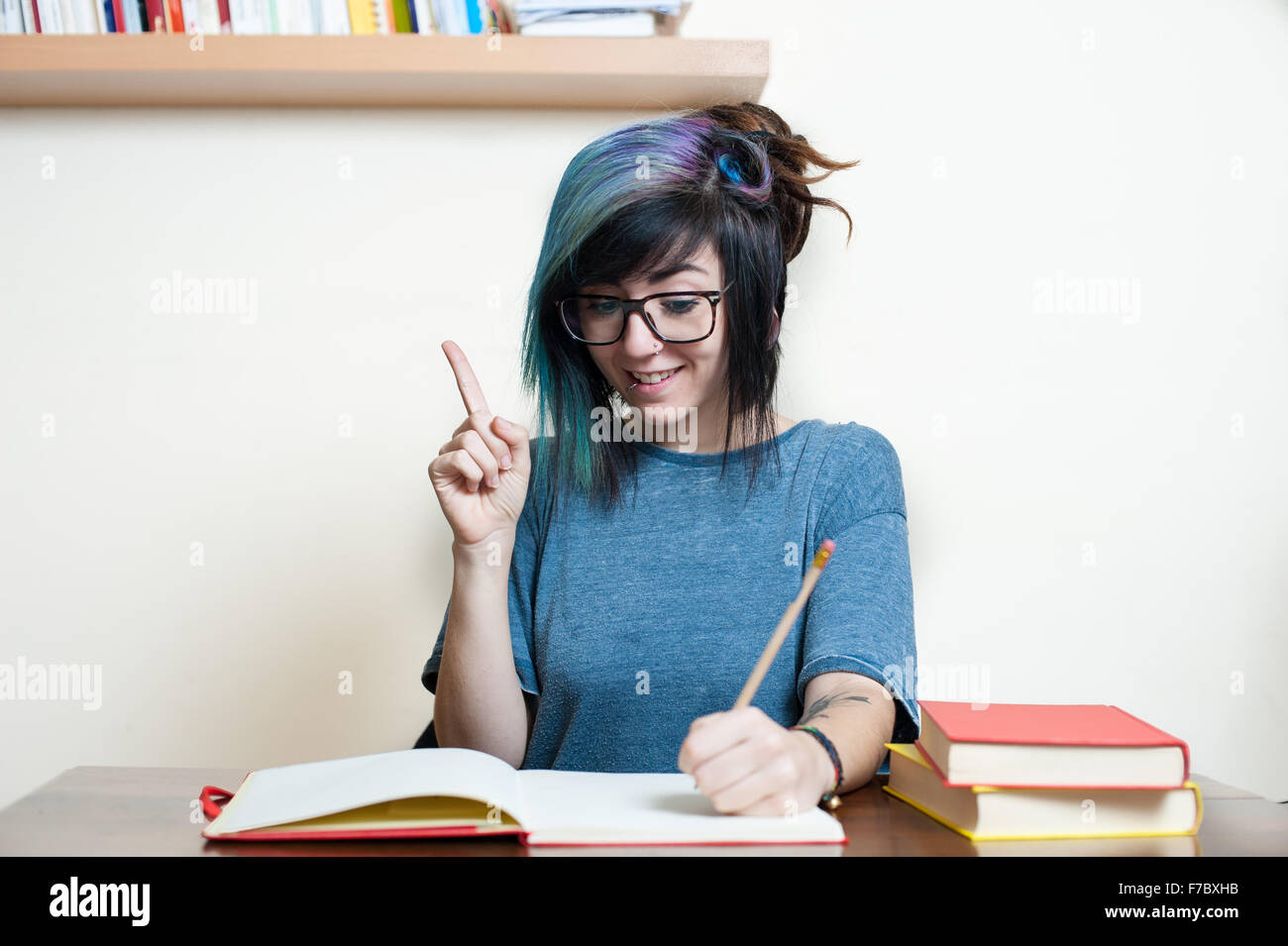 Young happy teen female student finding the answer while studying Stock ...