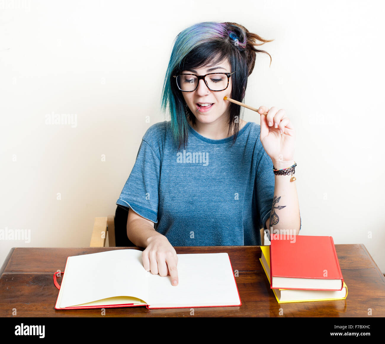Young happy teen female student finding the answer while studying on ...