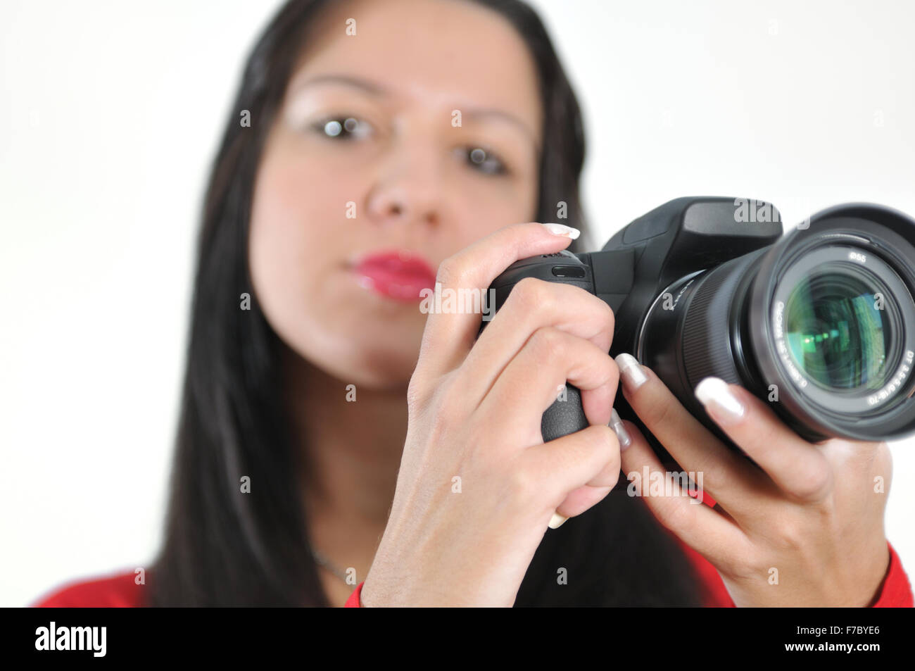 Young woman holding camera in hand taking picture isolated Stock Photo ...