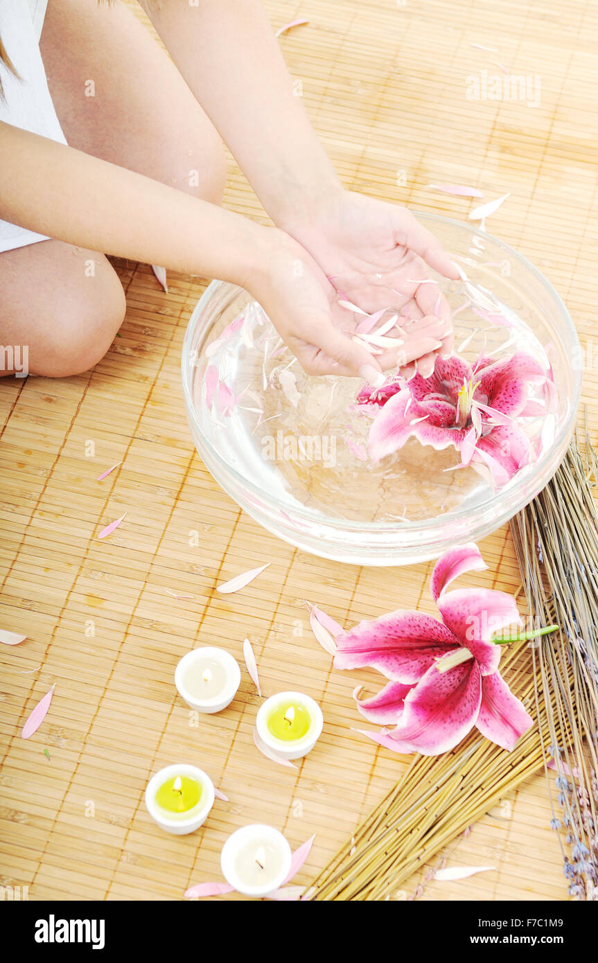 hand and nail spa and beauty treatment with aroma and flowers in water ...