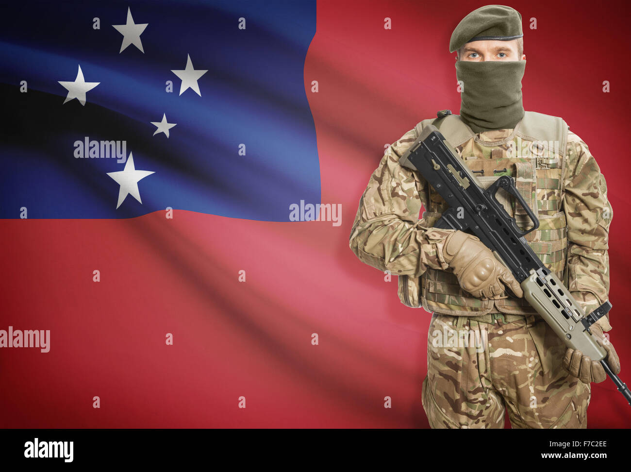 Soldier holding machine gun with national flag on background - Samoa ...