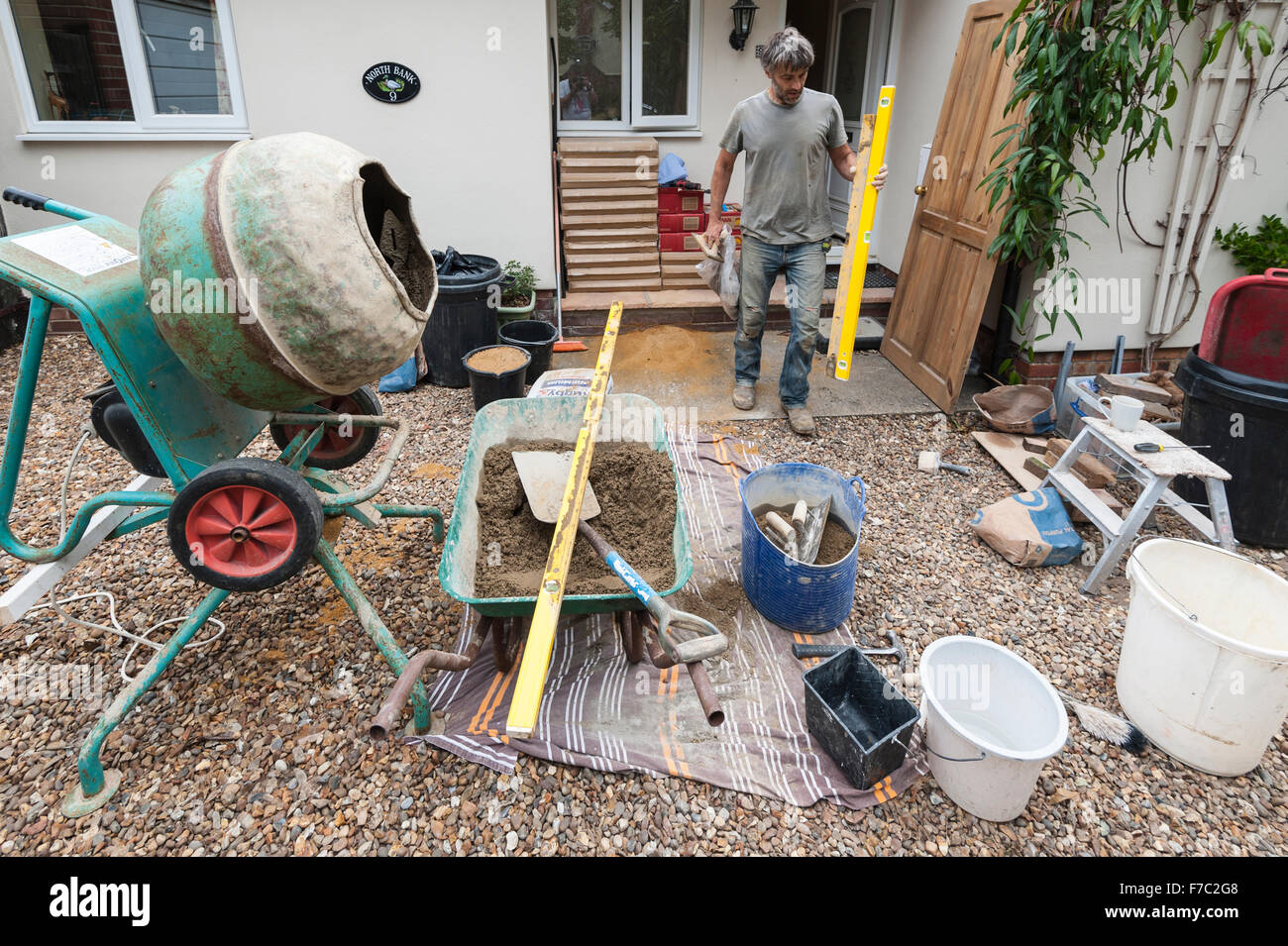 A builder with tools and materials working in a house in the Uk Stock ...