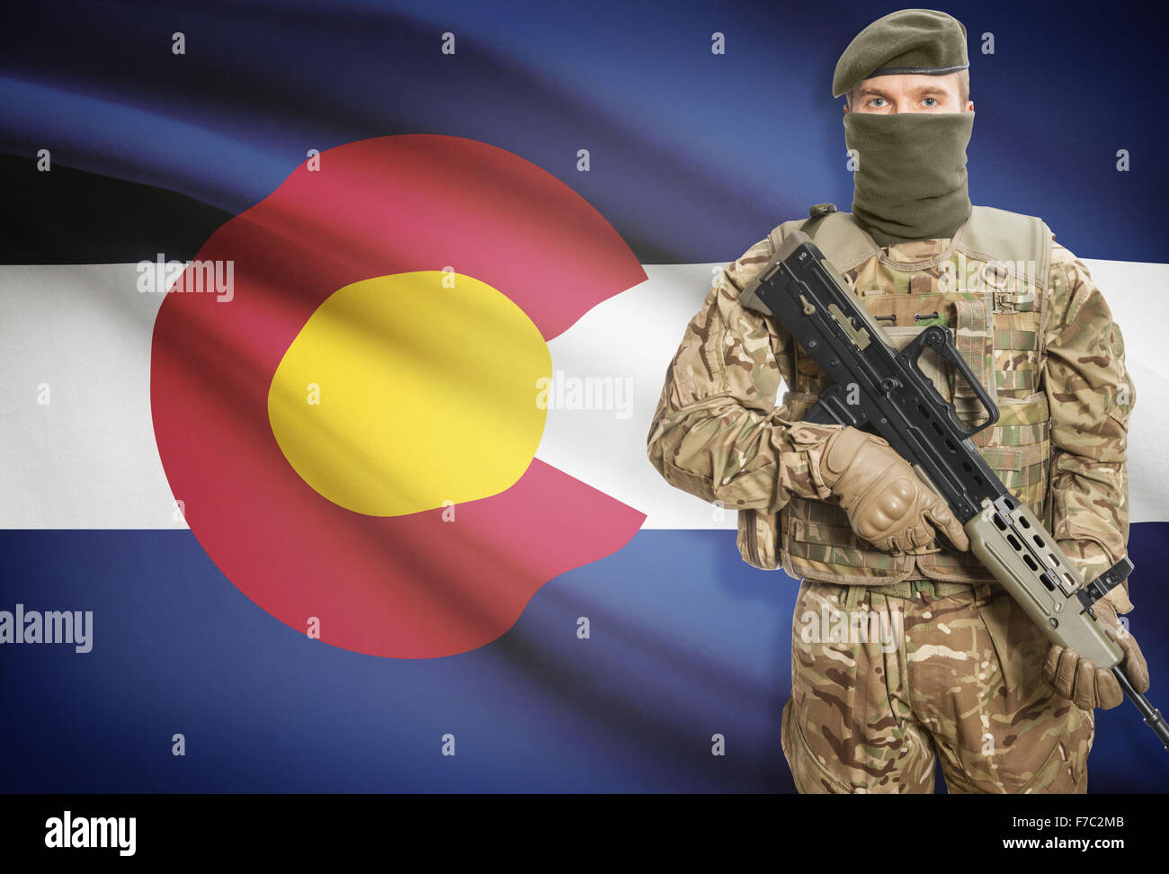 Soldier holding machine gun with USA state flag on background ...