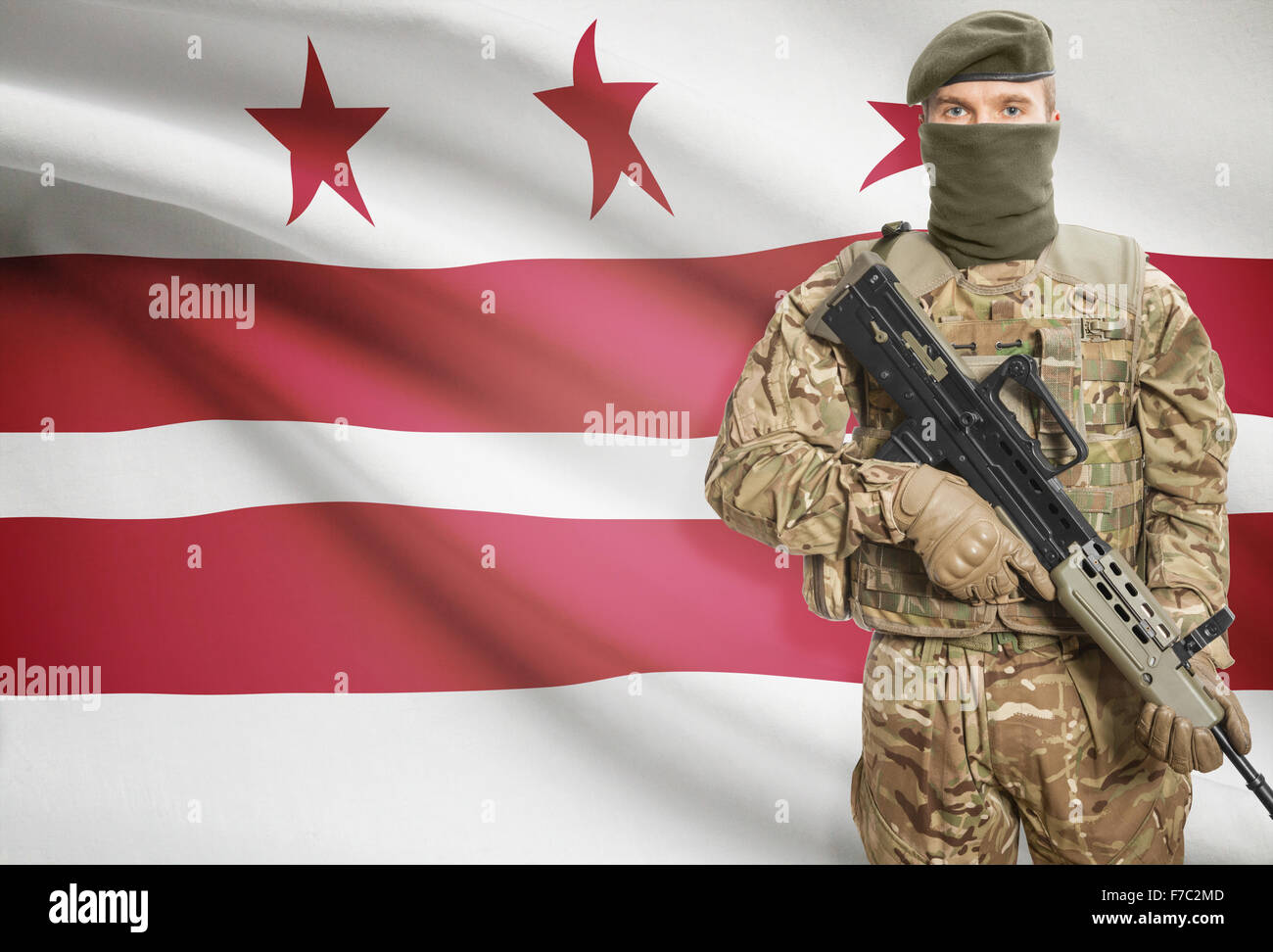 Soldier holding machine gun with USA state flag on background ...