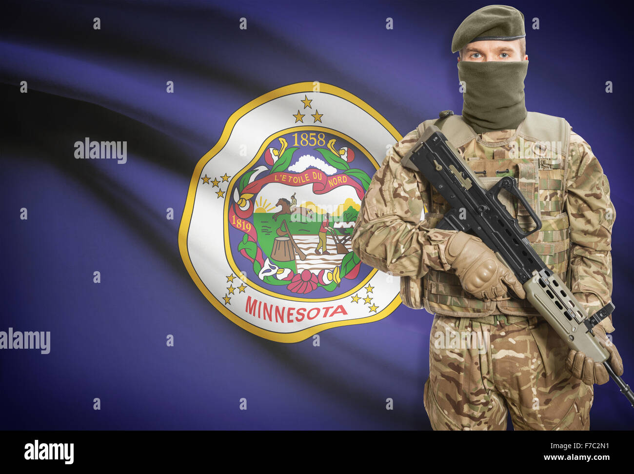 Soldier holding machine gun with USA state flag on background ...