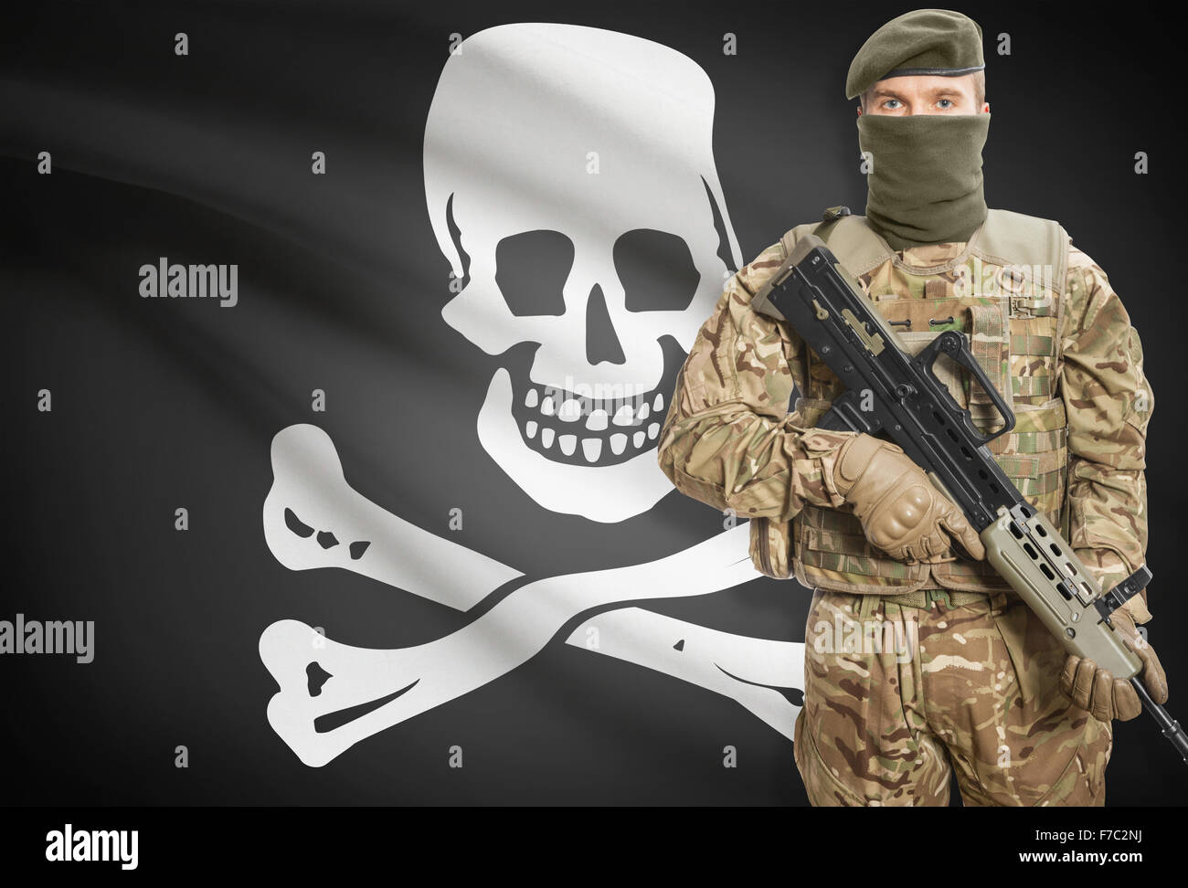 Soldier holding machine gun with flag on background - Jolly Roger ...