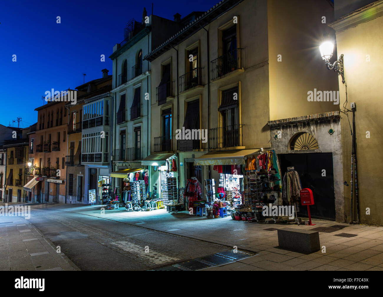 Night view of souvenir shops near the arch leading up to the Alhambra ...