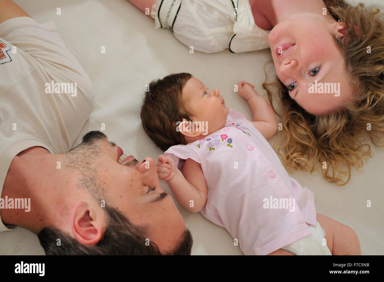 young family playing with cute little baby Stock Photo - Alamy