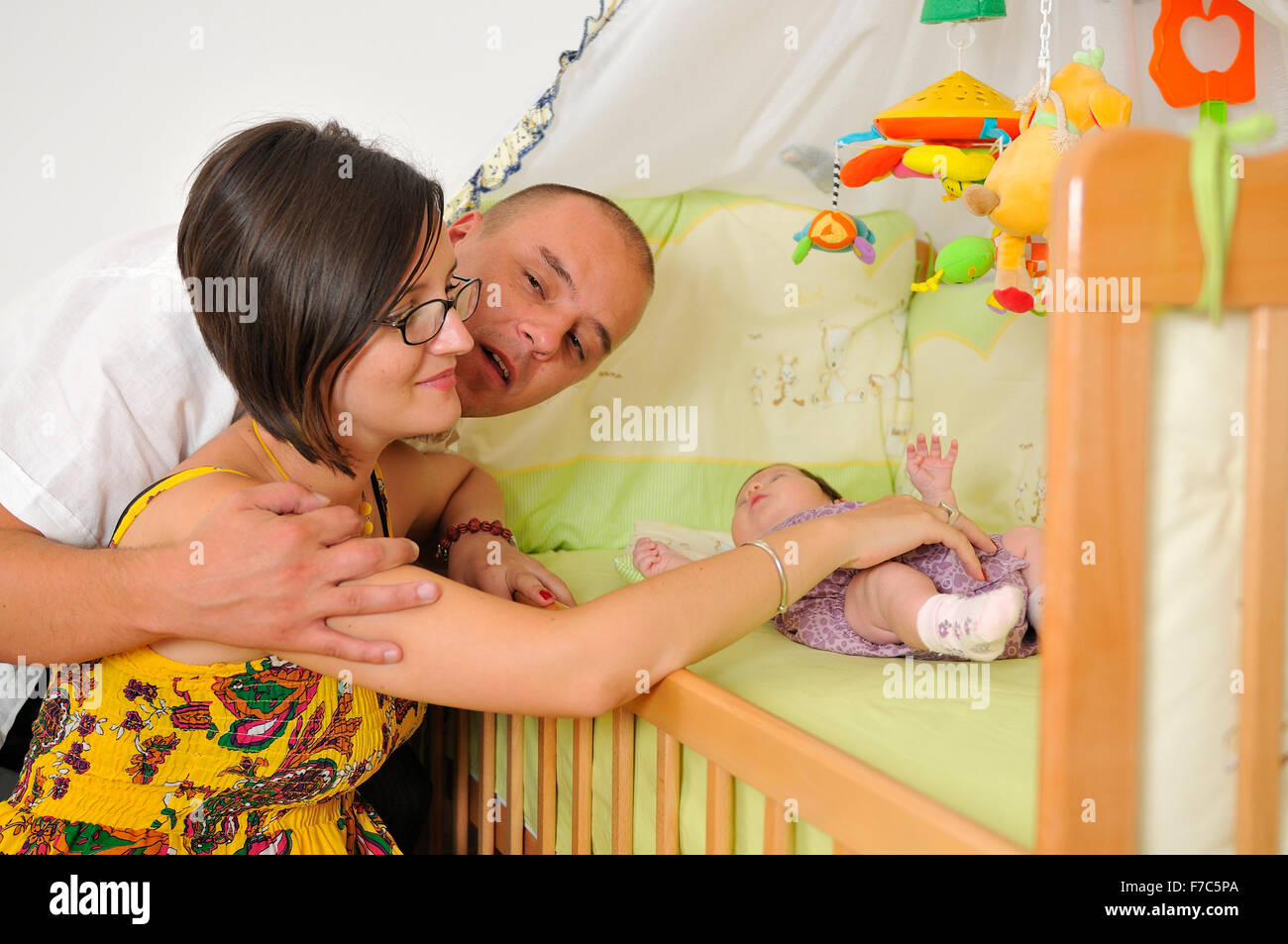 young family playing with cute little baby Stock Photo - Alamy