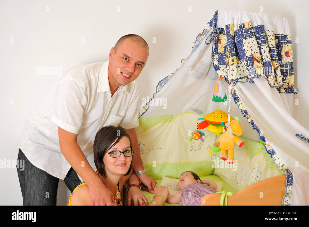 young family playing with cute little baby Stock Photo - Alamy