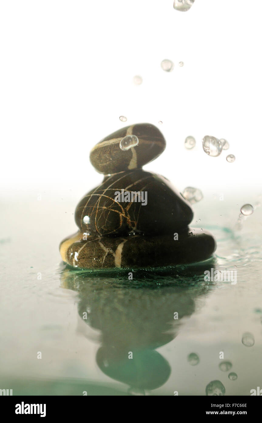 isolated zen stones in perfect harmony with falling and splashing water ...