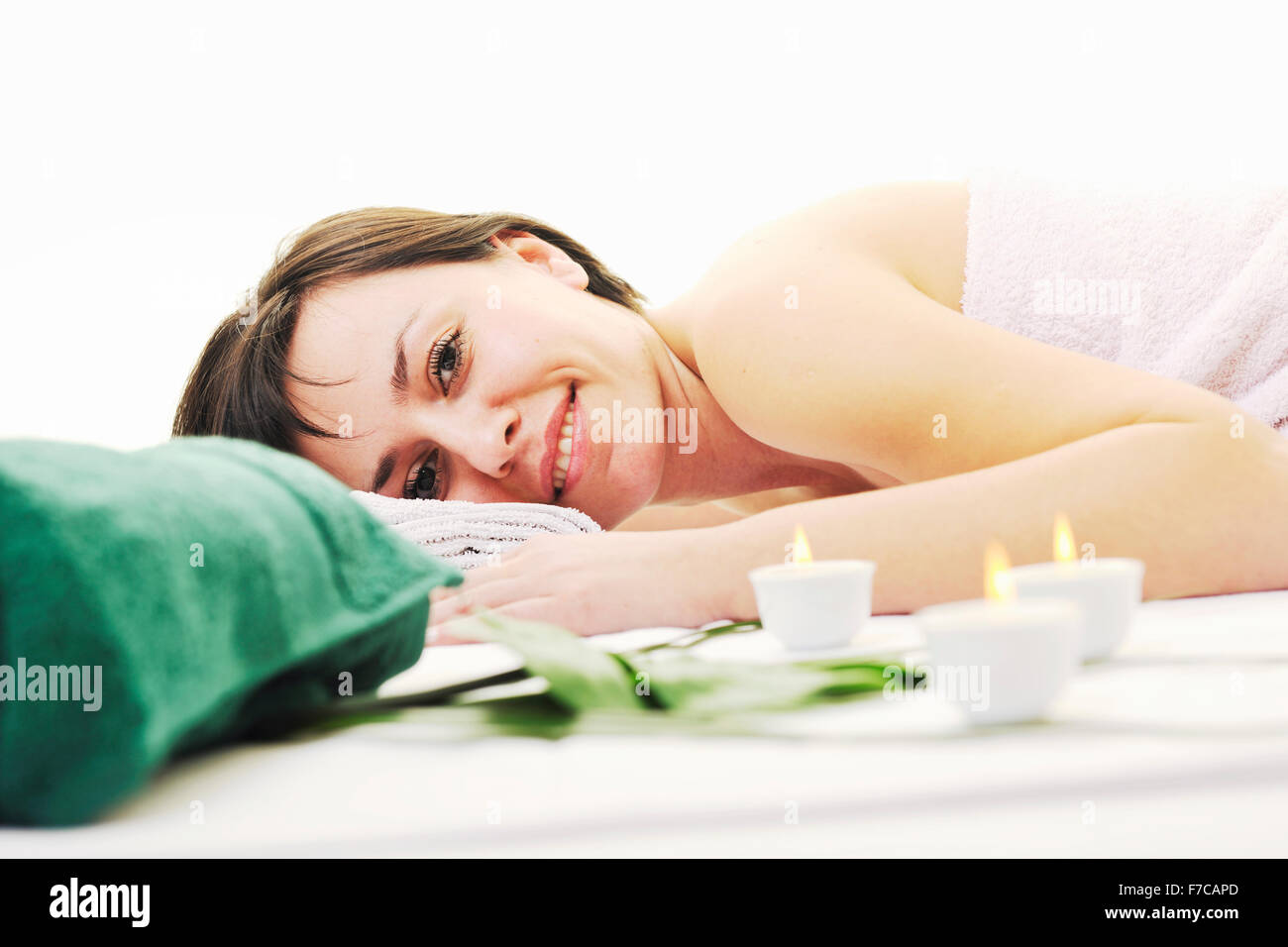 young woman relax and enjoy back massage treatment isolated on white ...