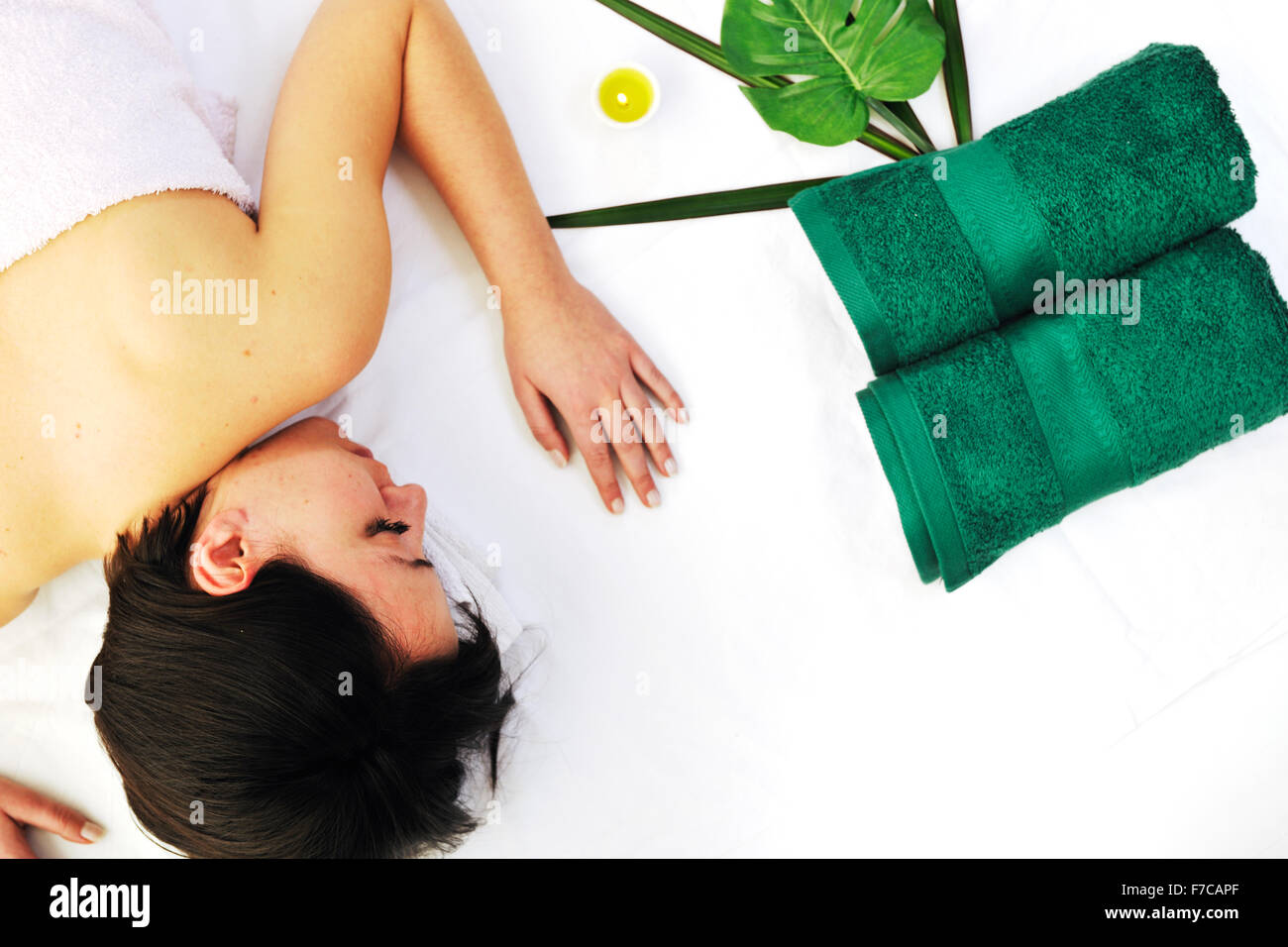 young woman relax and enjoy back massage treatment isolated on white ...