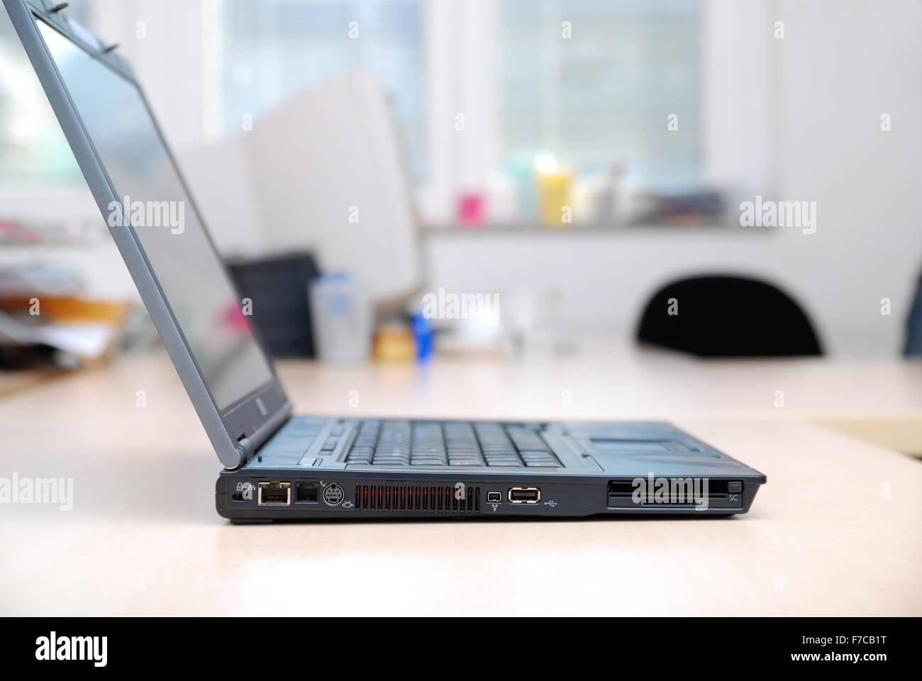 thin laptop on office desk Stock Photo - Alamy