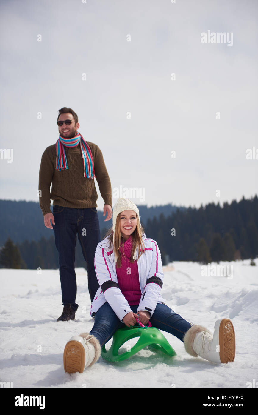 romantic winter scene, happy young couple having fun on fresh show on ...