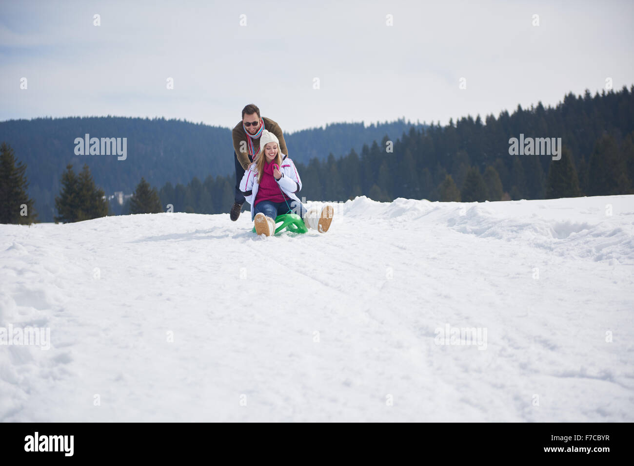 romantic winter scene, happy young couple having fun on fresh show on ...