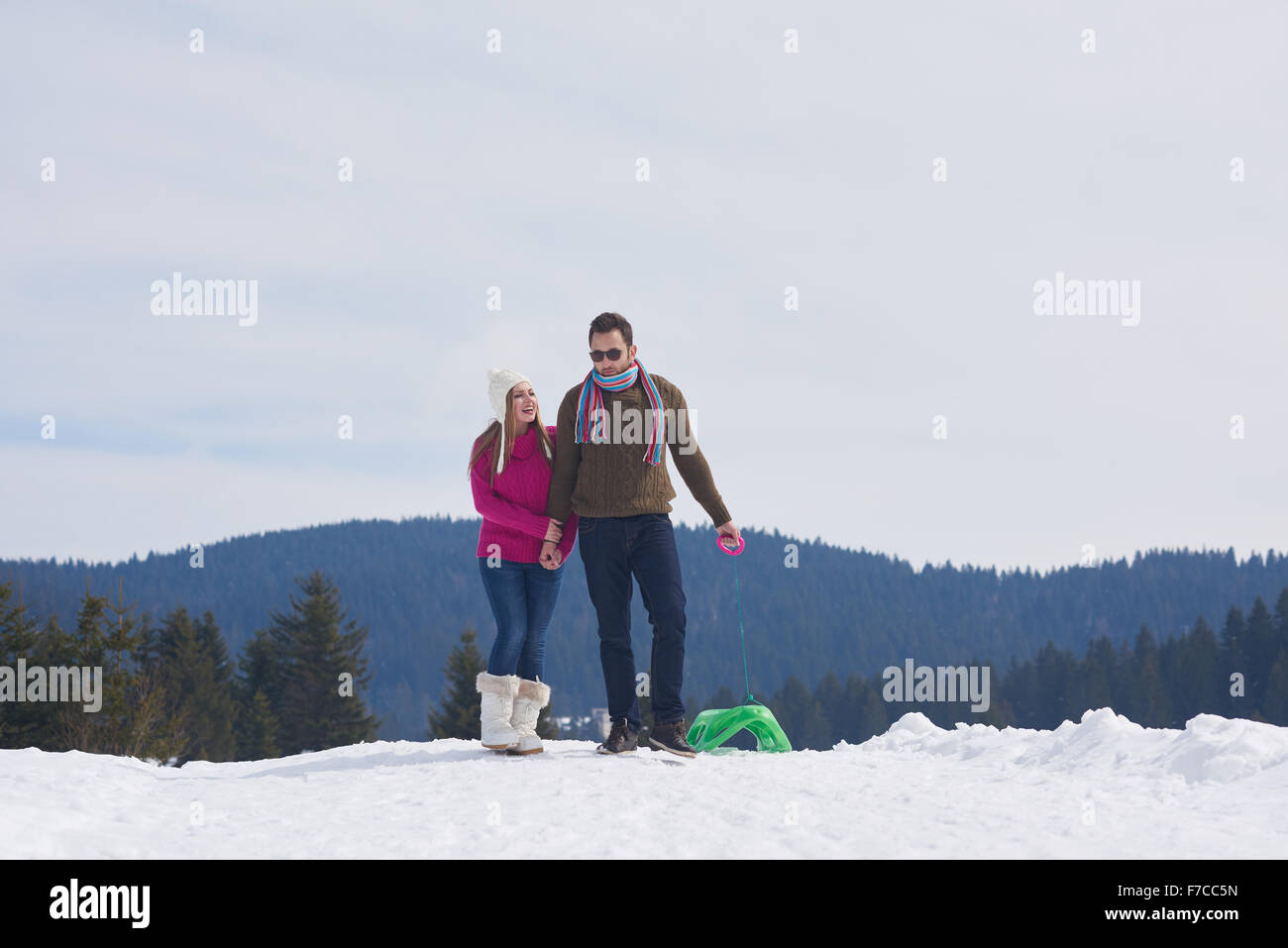 romantic winter scene, happy young couple having fun on fresh show on ...