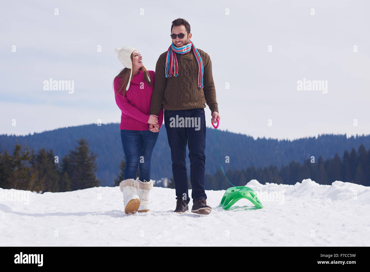 romantic winter scene, happy young couple having fun on fresh show on ...